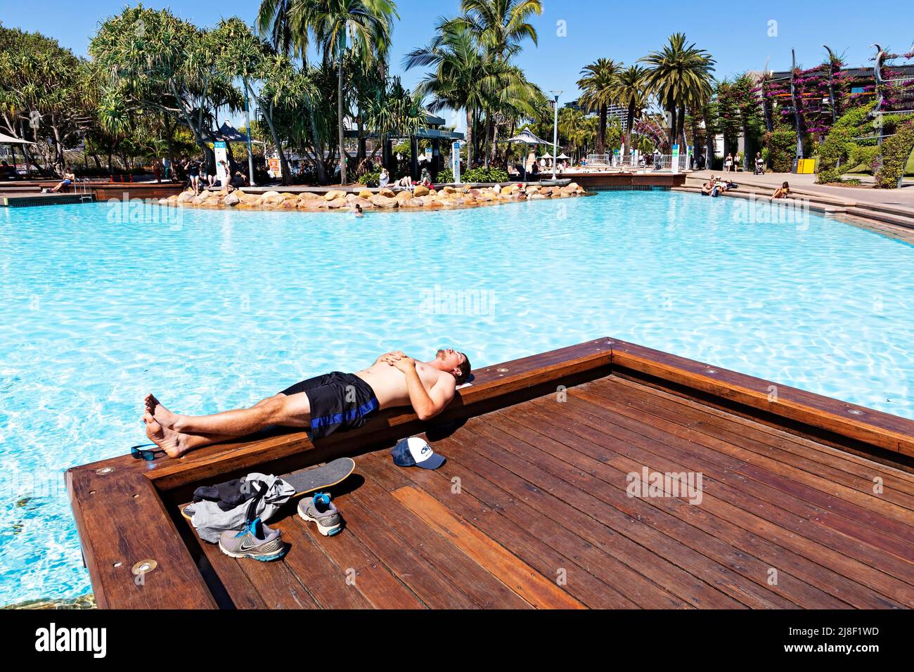 Young men sunbathing beach hi-res stock photography and images - Alamy