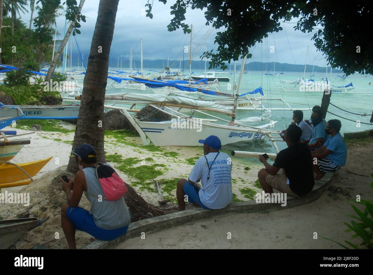 Local Men sat overlooking Paraw Boats, White Beach, Boracay, The ...