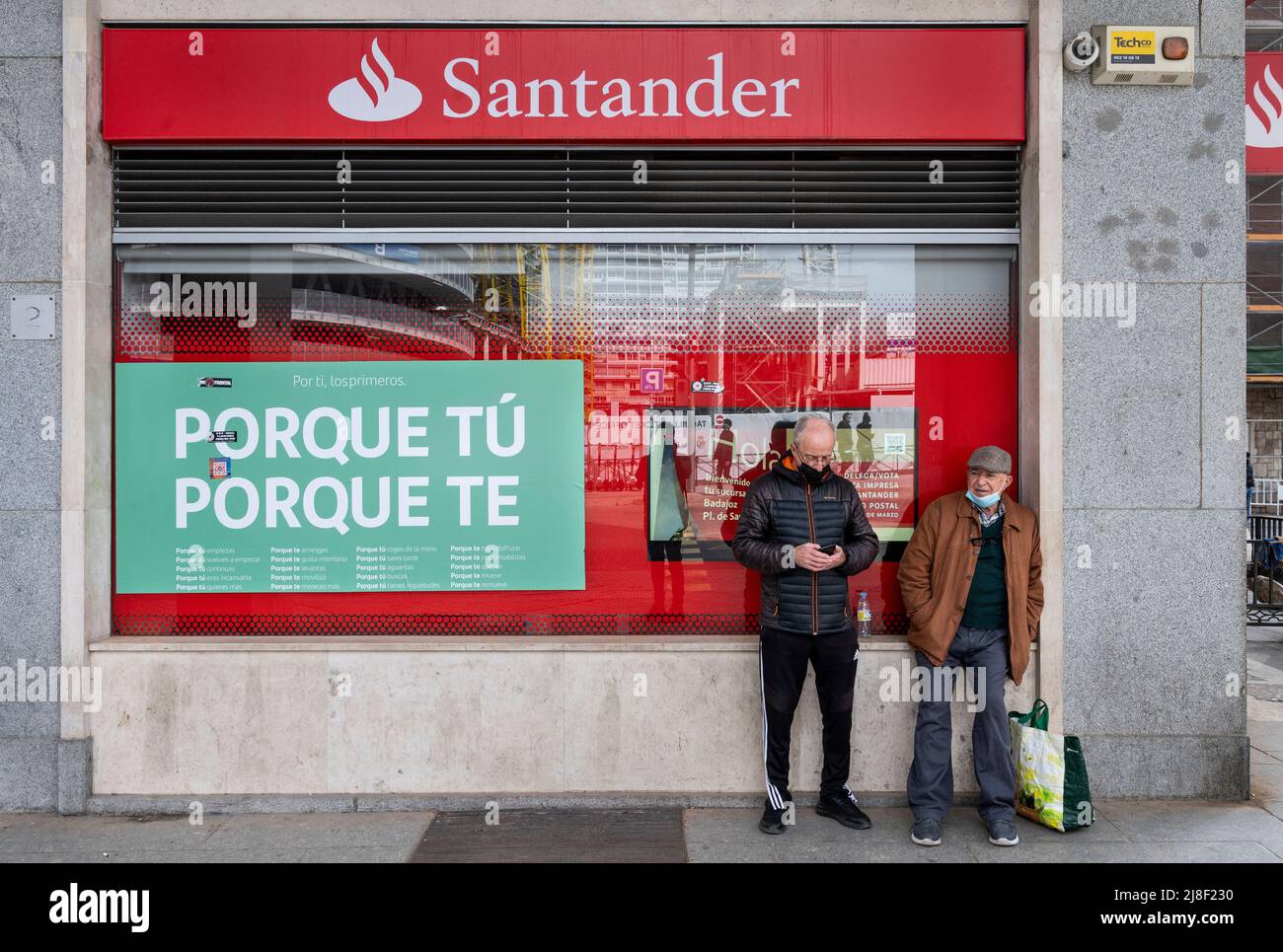 Pedestrians stand in front of the Spanish multinational commercial bank ...