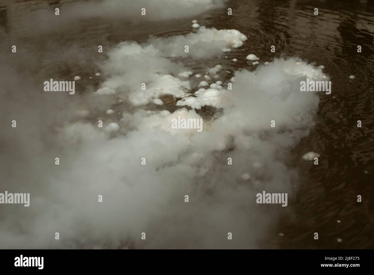 Dry ice evaporates in water. Smoke from chemical reaction. White ...