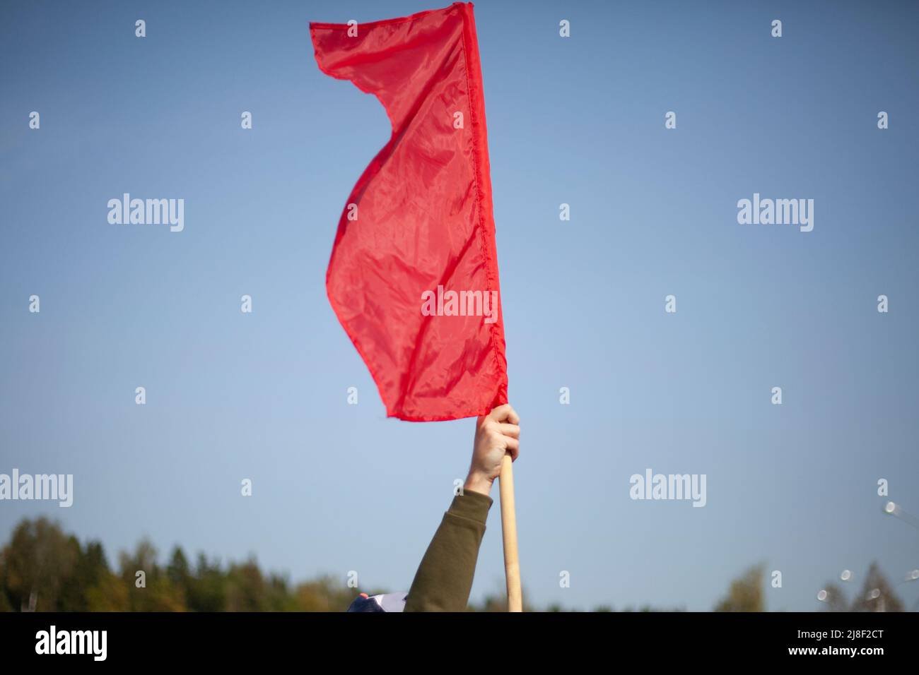 Red flag in hand. Signal flag. Man holds pole with red cloth. Symbol ...