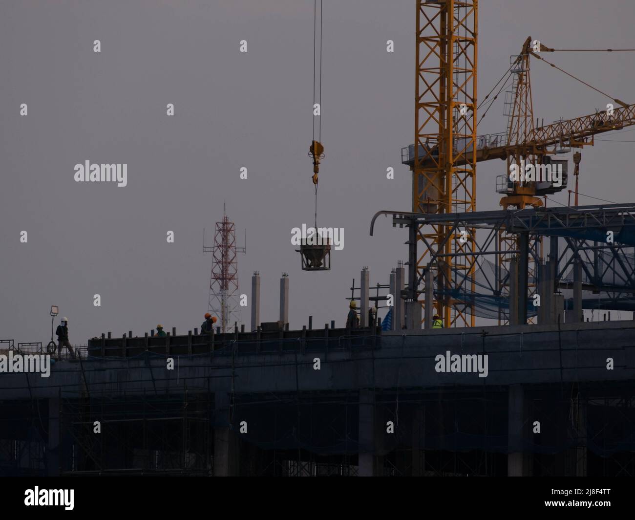 A large construction site with busy cranes. Tower cranes working on a ...
