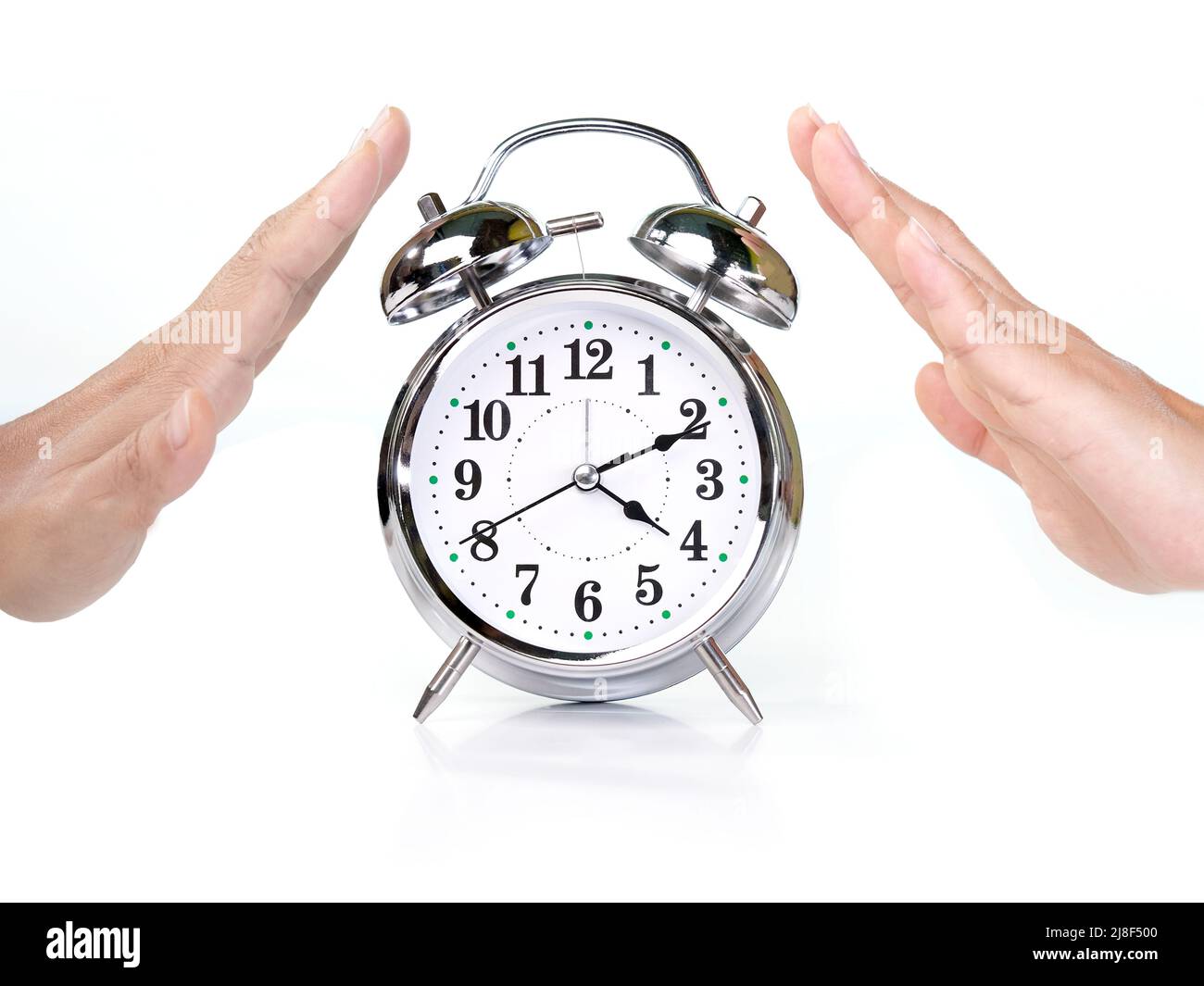 Retro alarm clock placed in the middle of a female hands making a stop ...