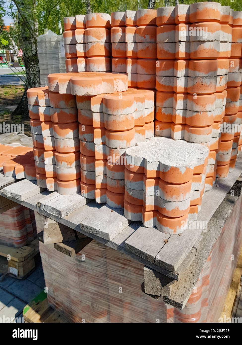 Close-up, the new paving slabs are neatly stacked on pallets. Repair of ...