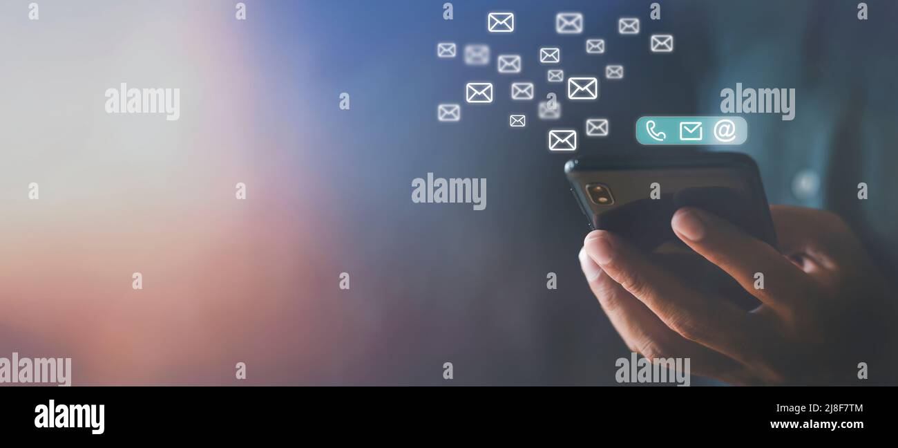 Hand holding using mobile phone with email icon on screen. Business ...