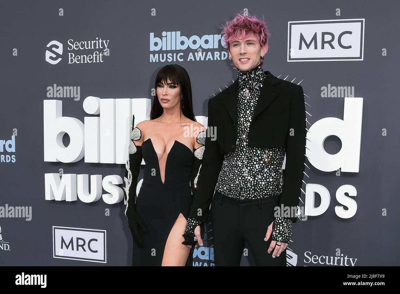 Megan Fox and Machine Gun Kelly walking on the red carpet at the 2022 Billboard Music Awards at ...