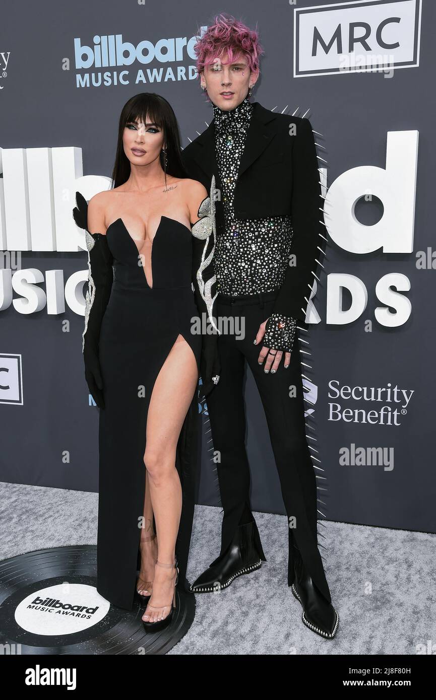 Megan Fox and Machine Gun Kelly walking on the red carpet at the 2022 Billboard Music Awards at ...