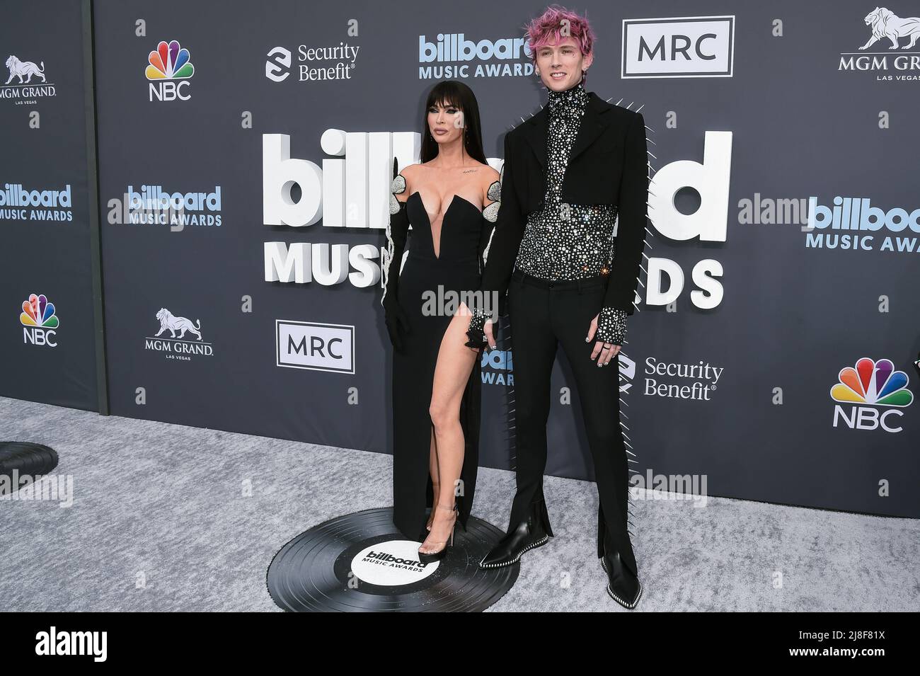 Megan Fox and Machine Gun Kelly walking on the red carpet at the 2022 Billboard Music Awards at ...