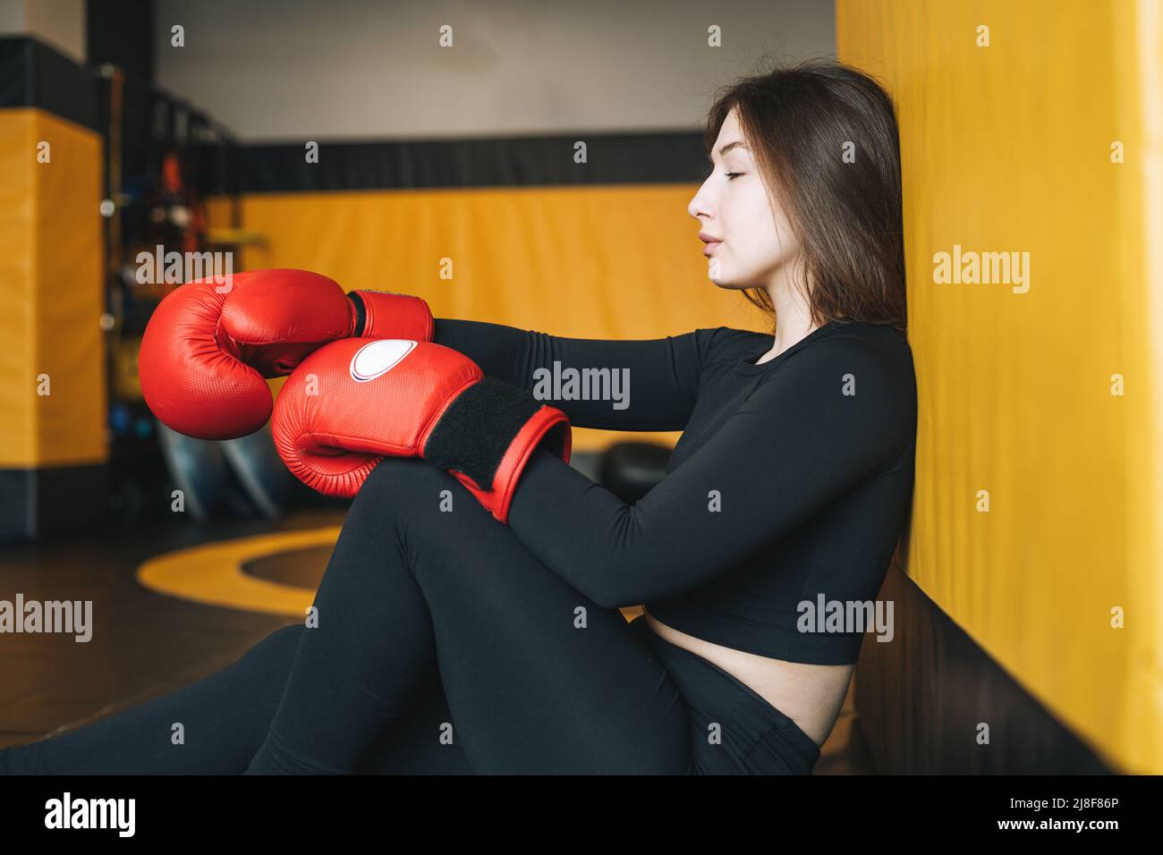 Young brunette woman in black wear engaged boxing training in the ...