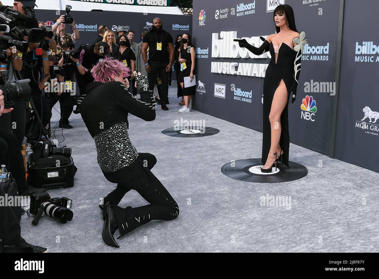 Machine Gun Kelly and Megan Fox walking on the red carpet at the 2022 Billboard Music Awards at ...