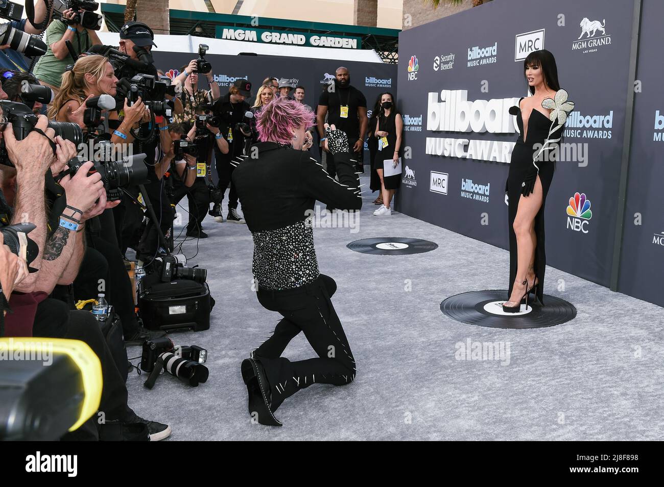Machine Gun Kelly and Megan Fox walking on the red carpet at the 2022 Billboard Music Awards at ...