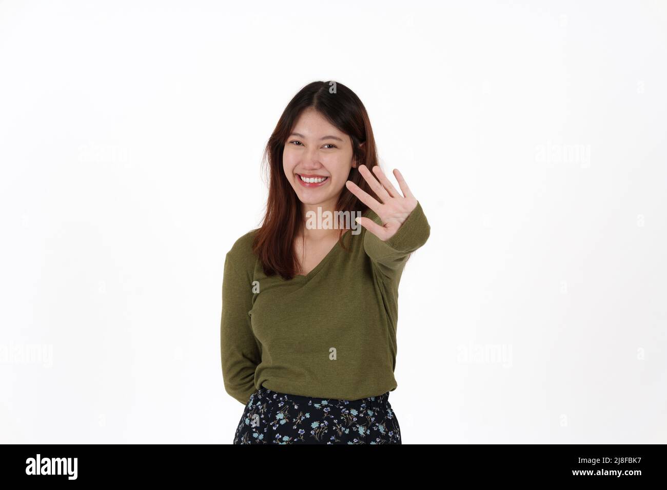 Image of happy young girl standing and Looking camera pointing isolated ...