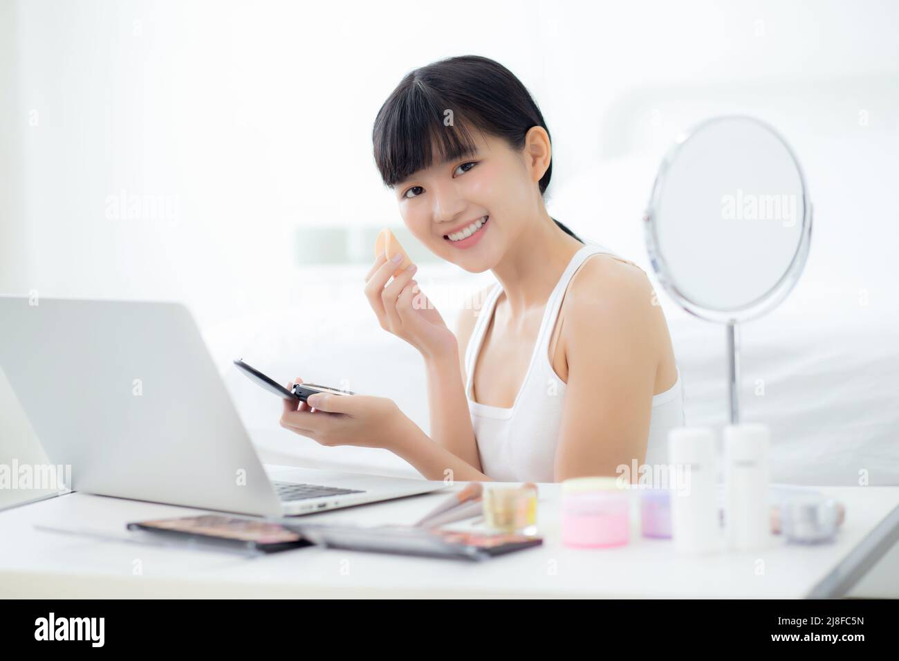 Beauty of young asian woman with learning makeup with powder puff on ...