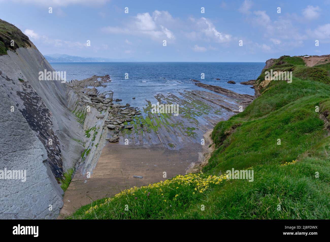 A view of the Flysch rock formations and cliffs with tidal pools on the ...