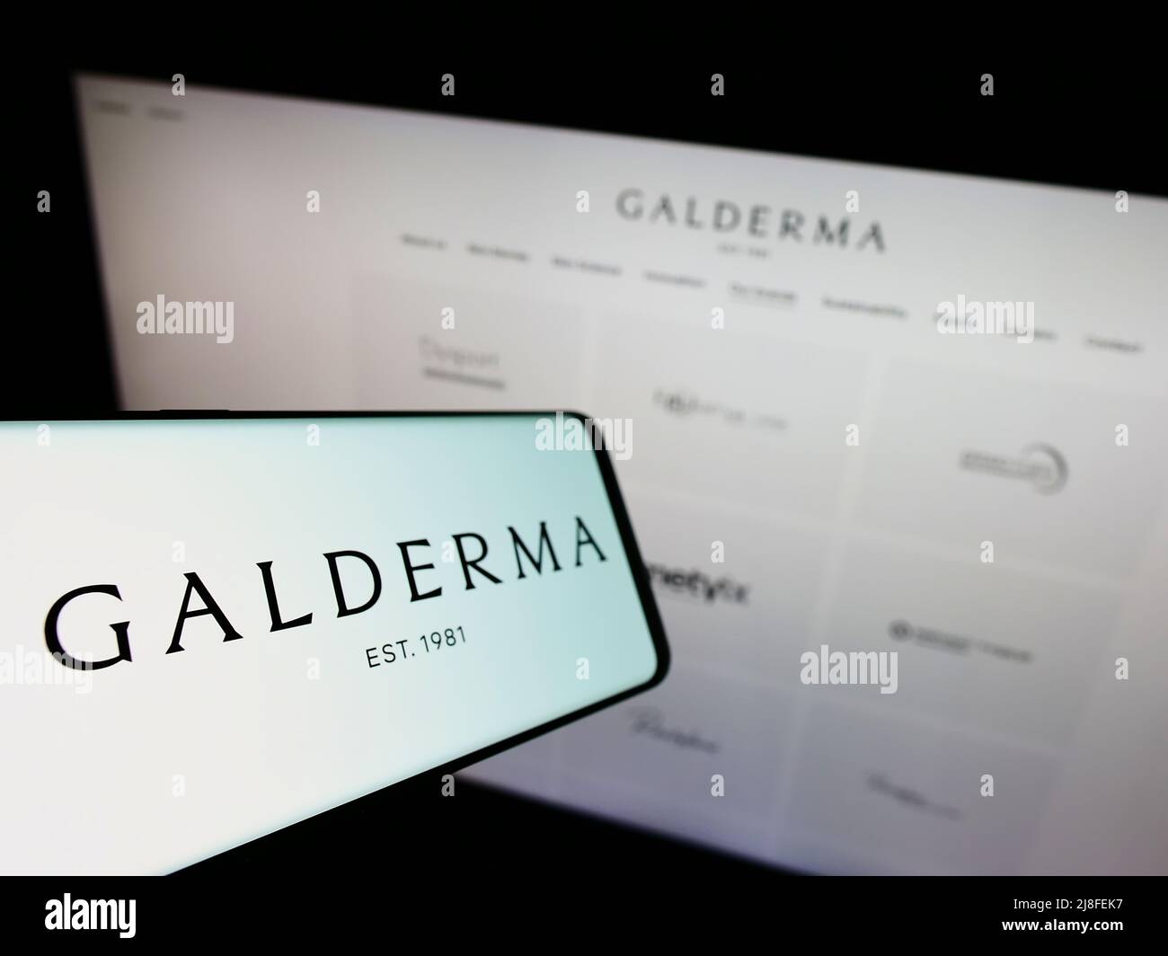 Cellphone with logo of Swiss pharmaceutical company Galderma S.A. on ...