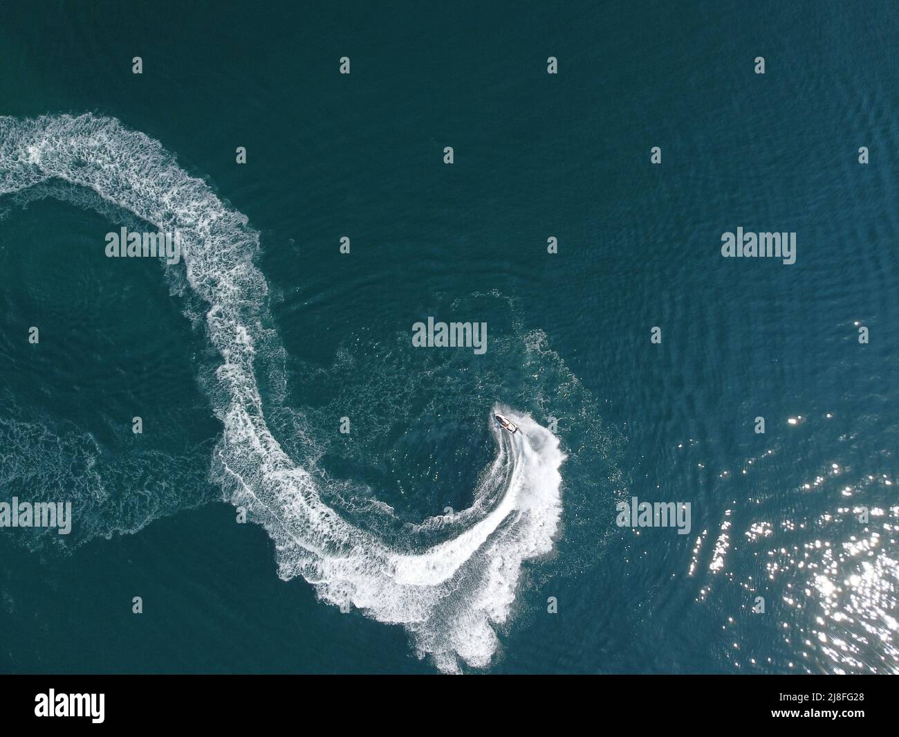 Aerial top down view of water foam trace with nice deep blue shade of ...