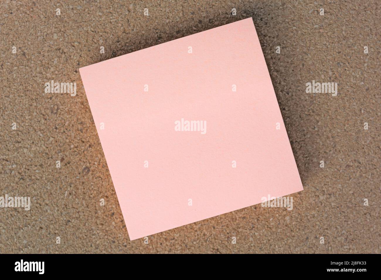 Sticky note on brown paper background. Directly above. Flat lay. Copy ...
