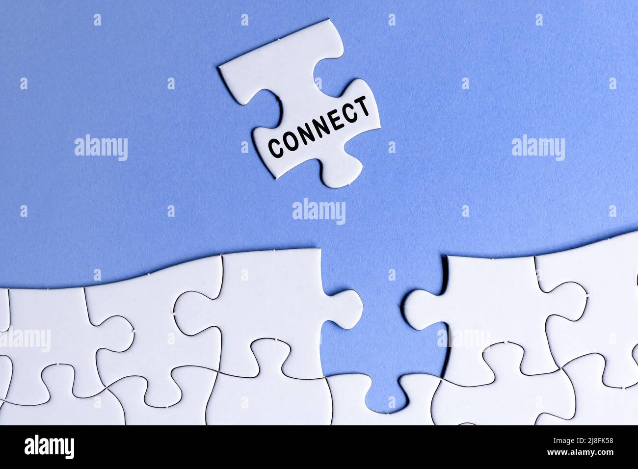 White jigsaw puzzle with word connect over blue background. Relationship concept Stock Photo - Alamy