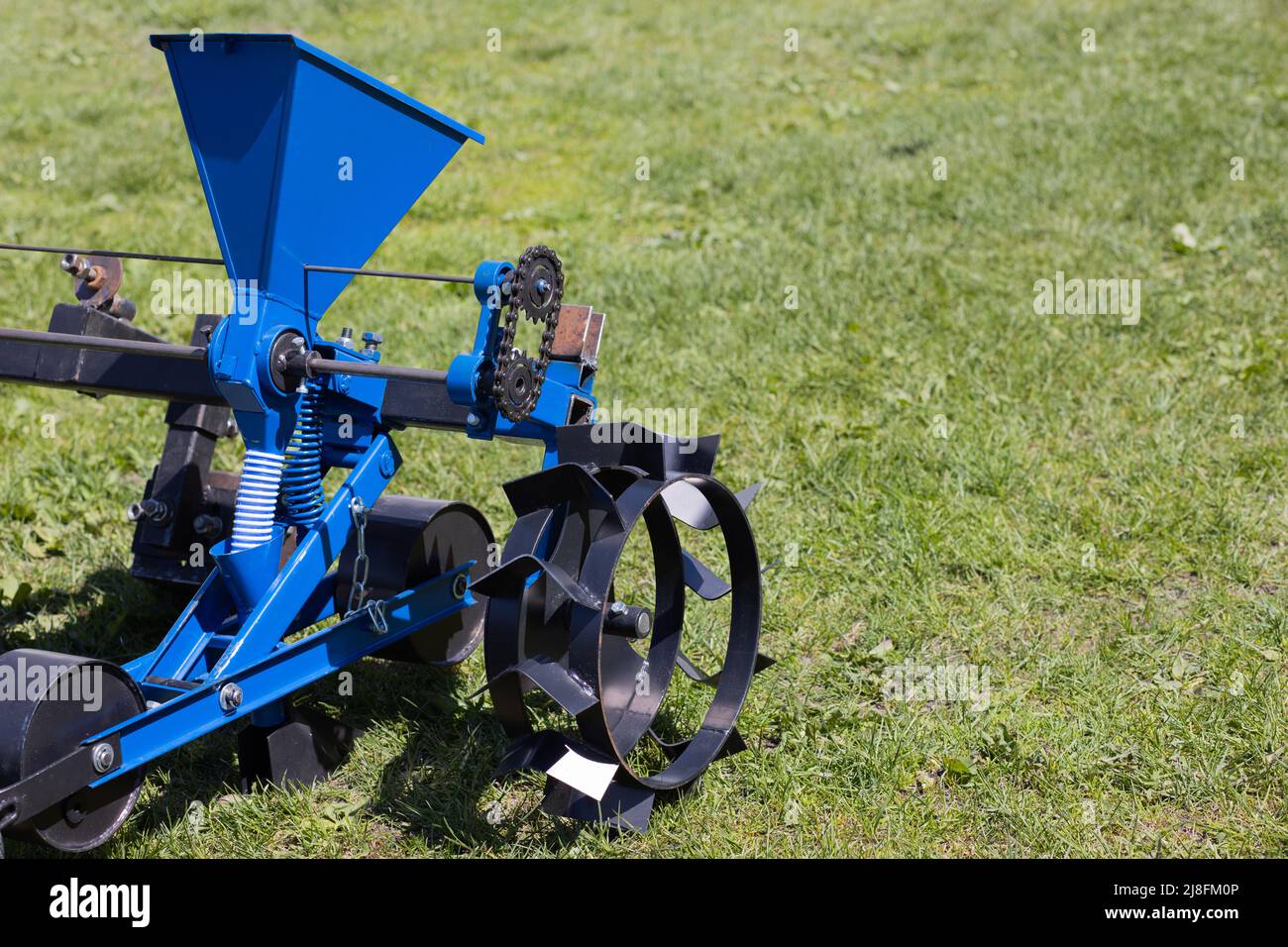 Close up of metal wheel and grain compartment of seeder Stock Photo - Alamy