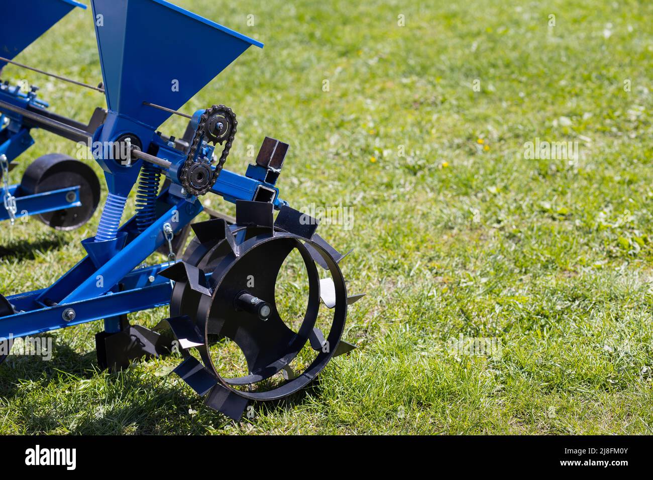 Close up of metal wheel and grain compartment of seeder Stock Photo - Alamy