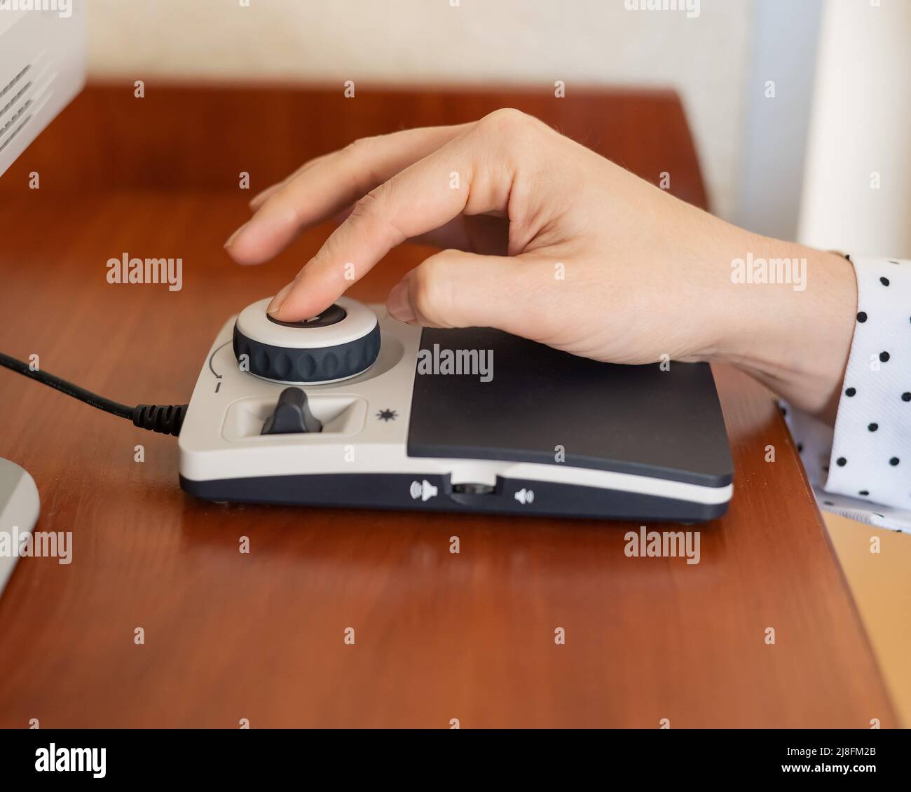 A woman uses a special magnification device for the visually impaired ...