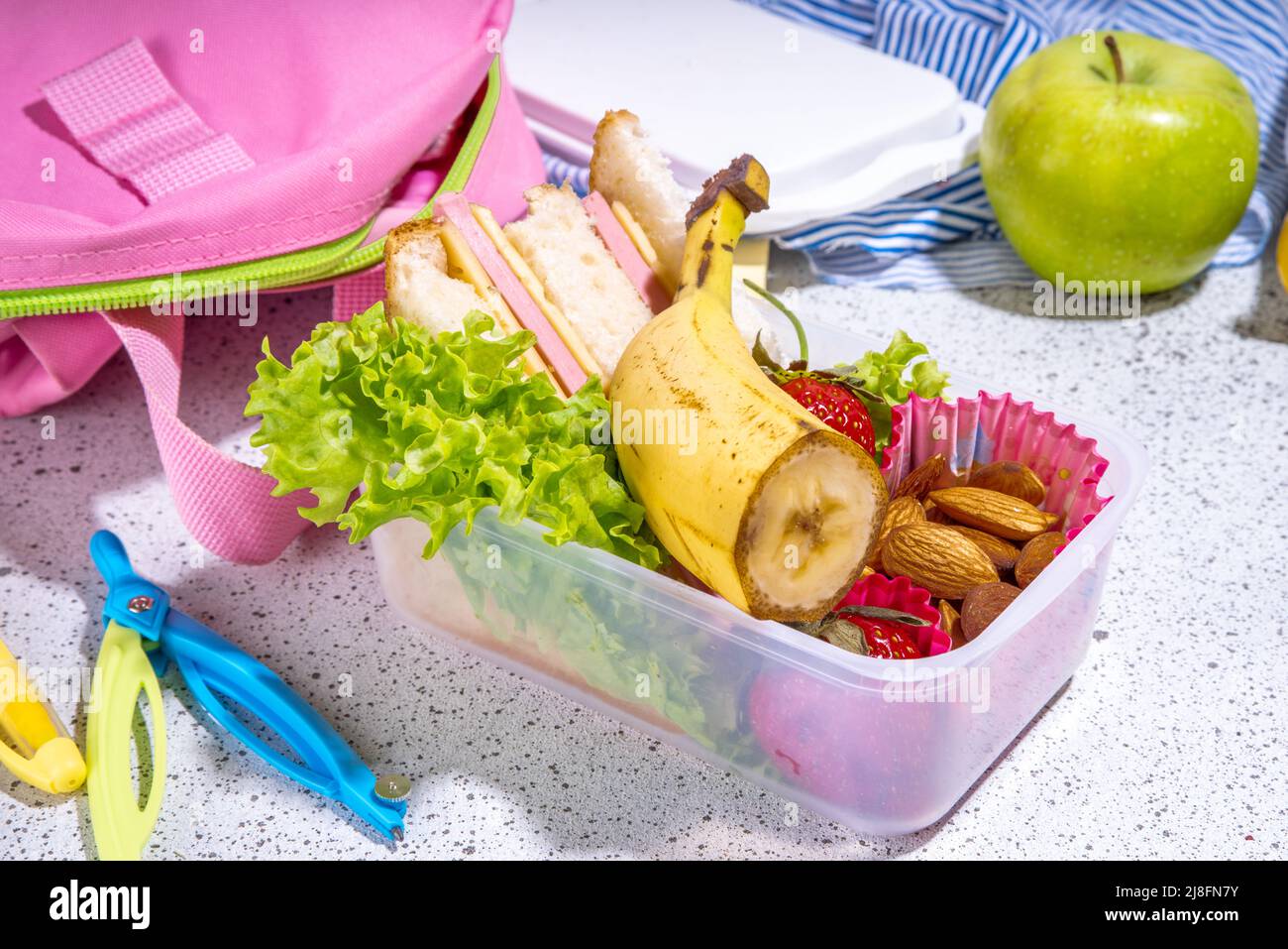Healthy school lunch box: sandwich, vegetables, fruit, nuts and yogurt ...