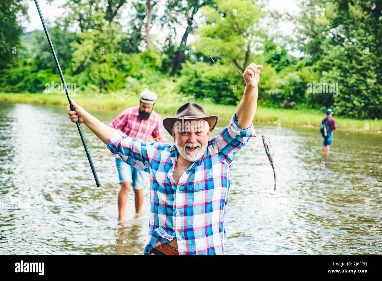 Portrait of cheerful senior man fishing. Excited senior man fisherman ...