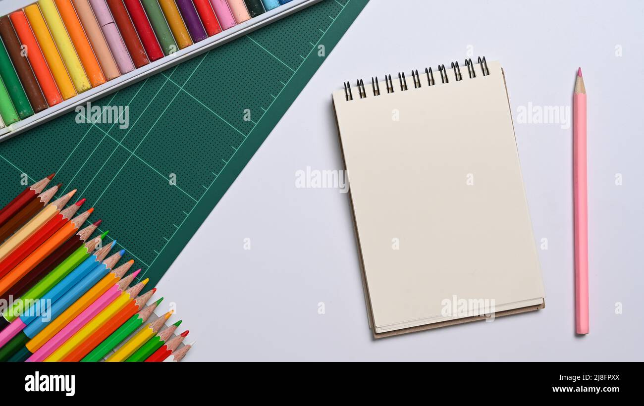 Notebook with school supplies on white table . Back to school. concept ...