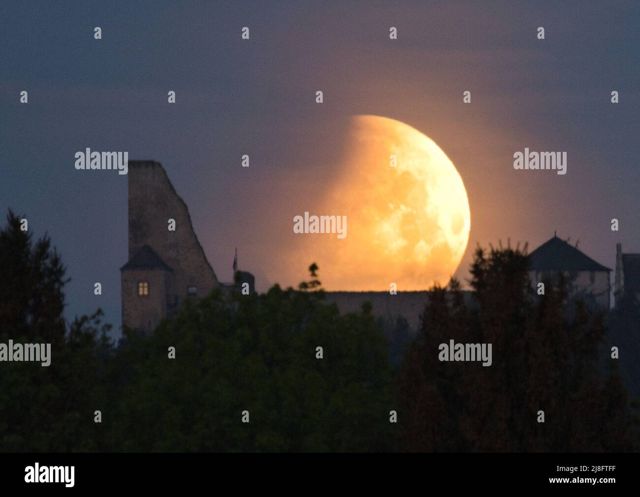 Partial lunar eclipse over Lipnice nad Sazavou castle, Czech Republic ...