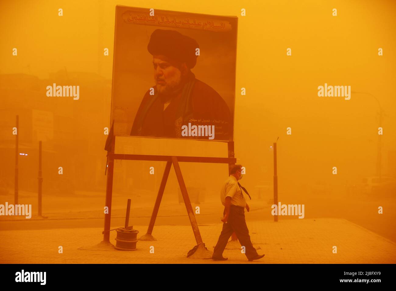 Baghdad, Iraq. 16th May, 2022. A man walks on a street covered with ...