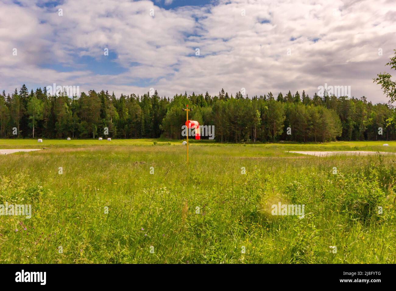 Windsock on green field and forest background Stock Photo - Alamy