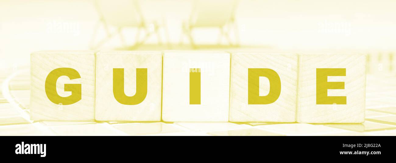 Guide Word Written In Wooden Cubes on relaxed beach landscape ...