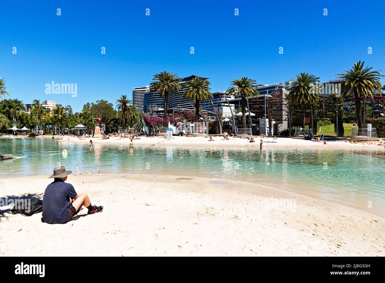 Brisbane Australia / A man enjoys the sunshine at Streets Beach an ...