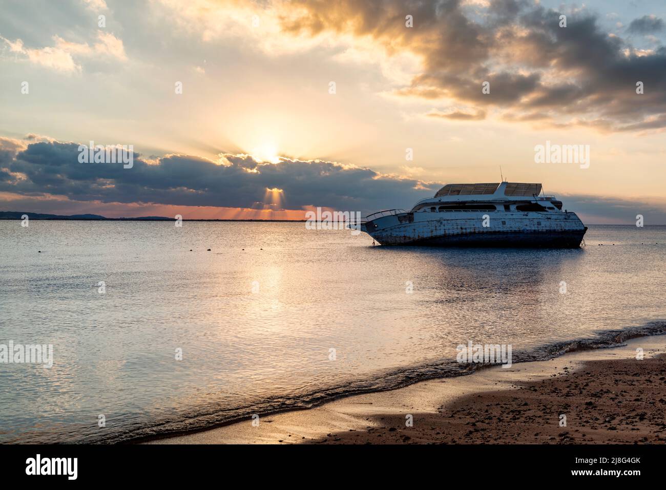 Beautiful sunrise landscape on a beach with old sunk boat Stock Photo ...