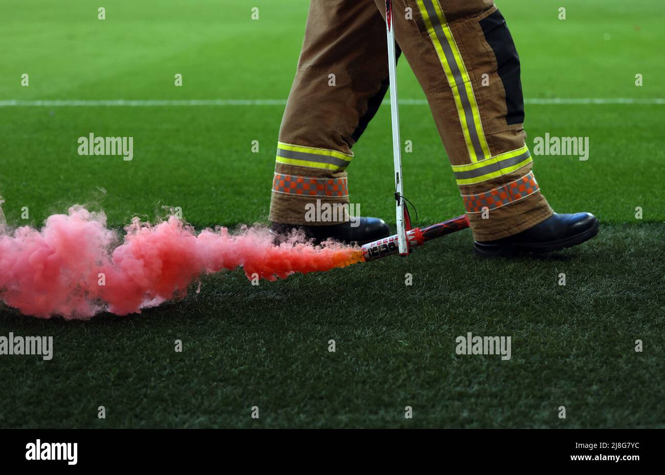 London, UK. 14th May, 2022. A flare is removed from the pitch by a ...