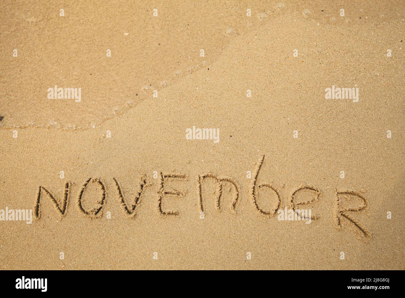 November - drawing handwritten on the sea beach sand Stock Photo - Alamy