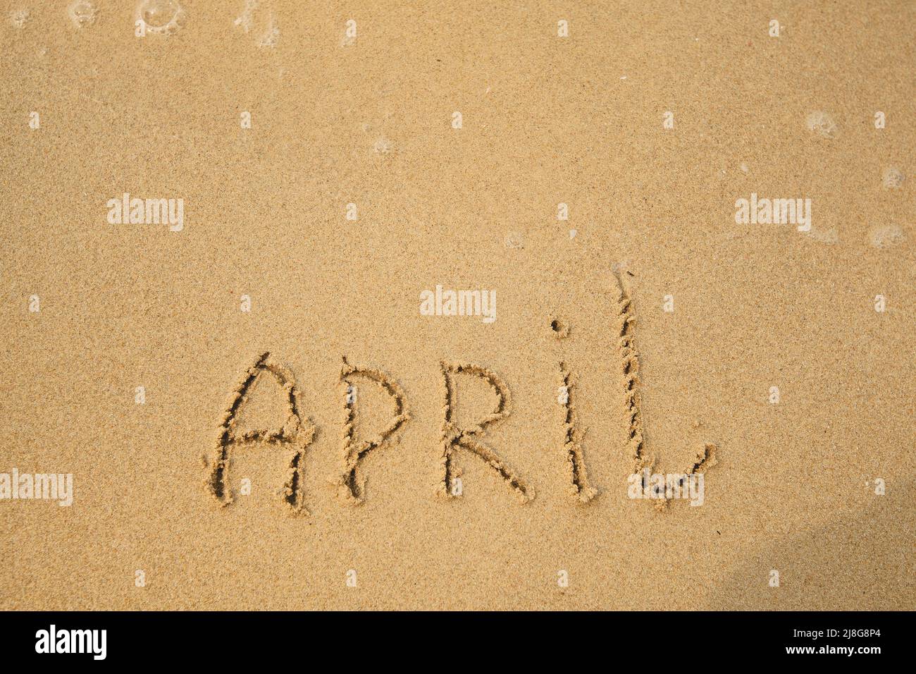 April - drawing handwritten on the sea beach sand Stock Photo - Alamy
