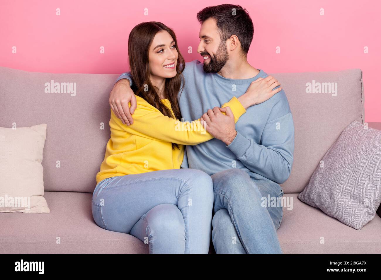 Portrait of attractive cheerful gentle couple bonding sitting on divan romance free time ...