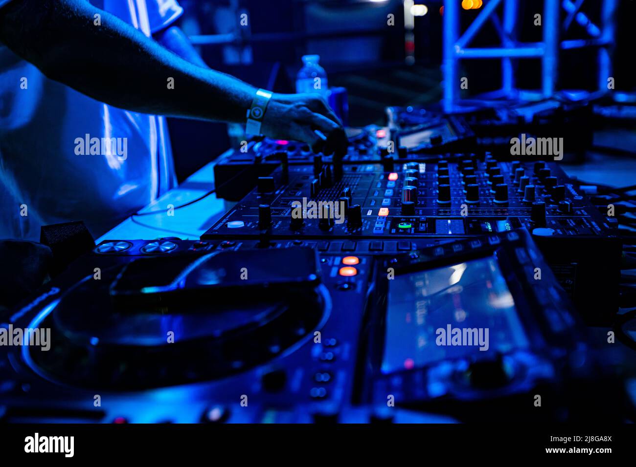 DJ hand on mixing equipment at night club Stock Photo - Alamy