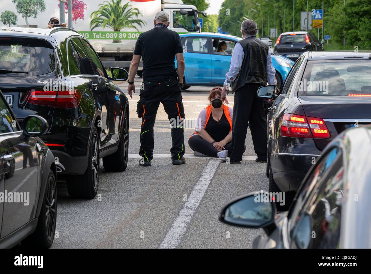 Munich, Germany. 16th May, 2022. Motorists stand in front of a climate ...