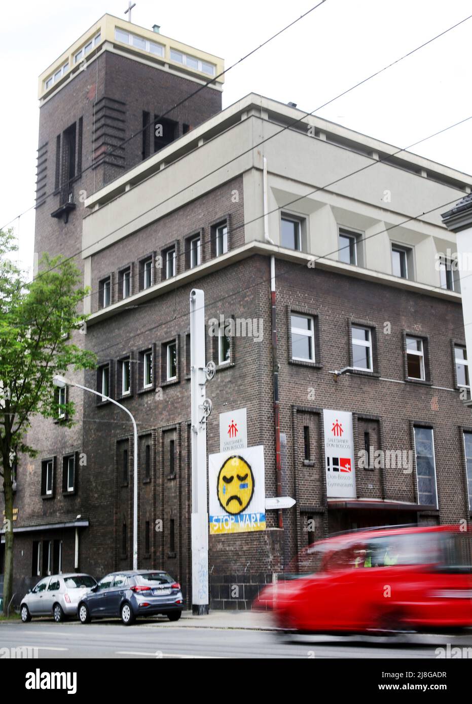 Essen, Germany. 16th May, 2022. A car drives past the school building ...