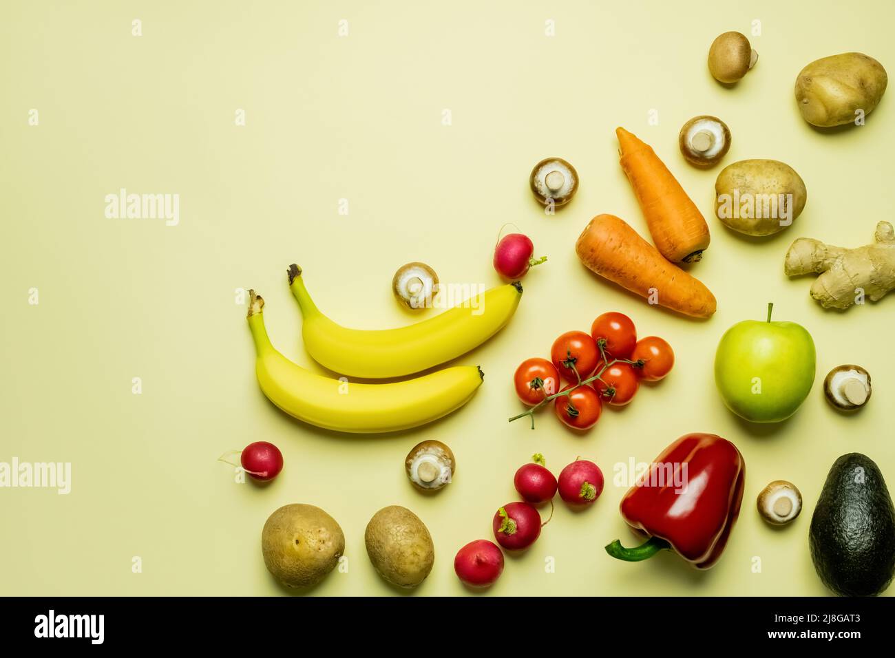 Flat lay of natural fruits and vegetables on yellow background Stock ...
