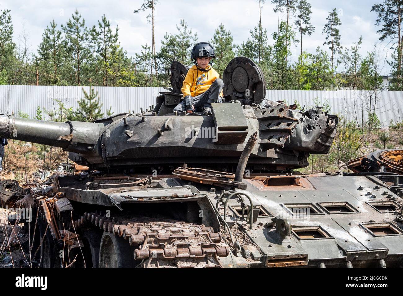 A child sitting on a destroyed Russian tank. (Photo by Michael ...