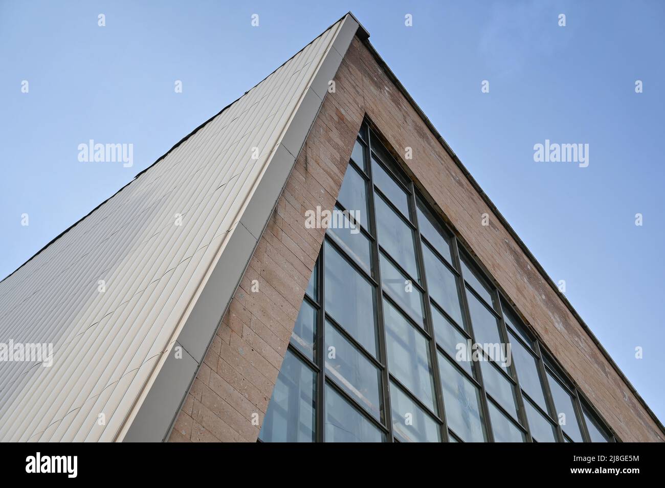 Geometric composition of glass and concrete against a blue cloudless ...