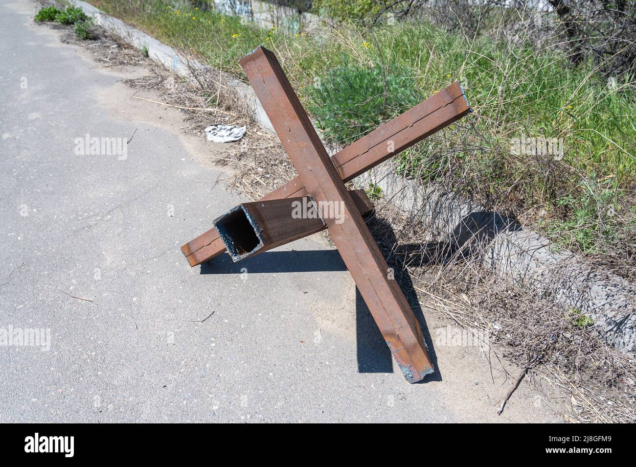 Anti-tank obstacles in the street of a Ukrainian city. Metal barrier ...