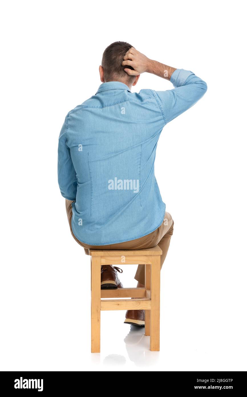 confused man in denim shirt scratching head and thinking of ways to ...