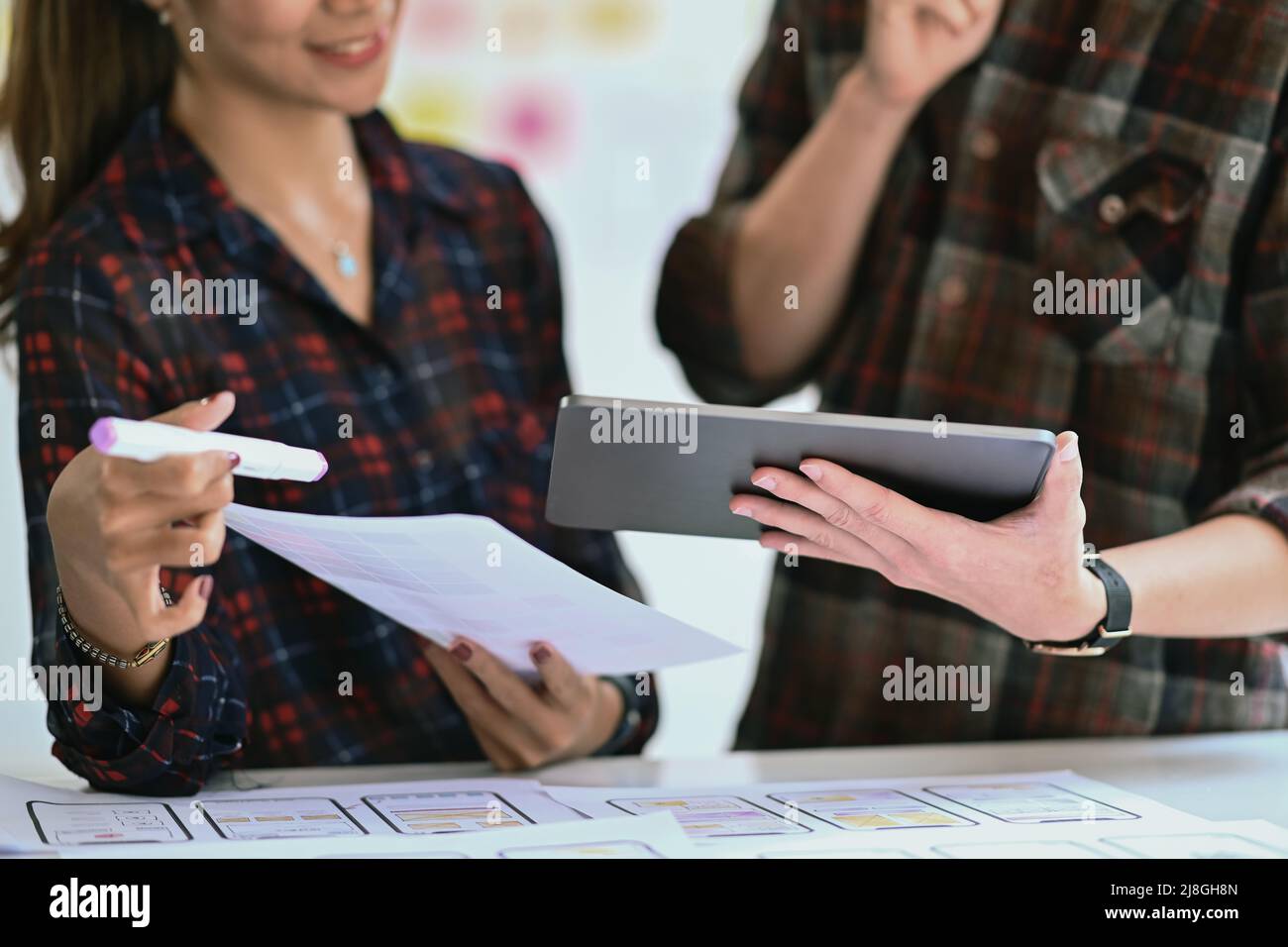 Creative Designers Brainstorming And Planing About Mobile Application Interface Wireframe Design