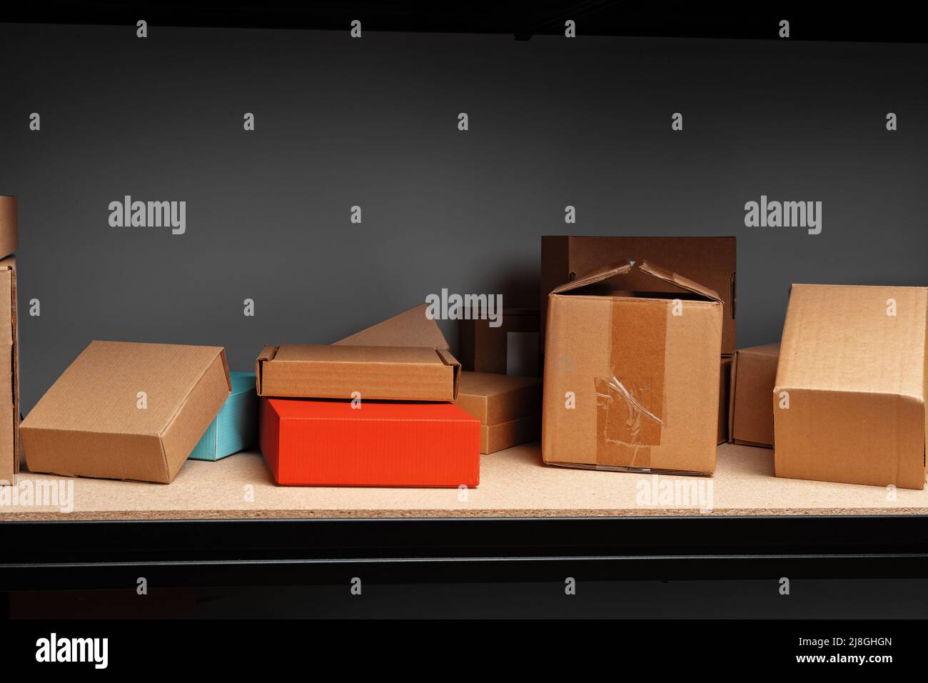 Rows of shelves with cardboard boxes in modern warehouse Stock Photo ...