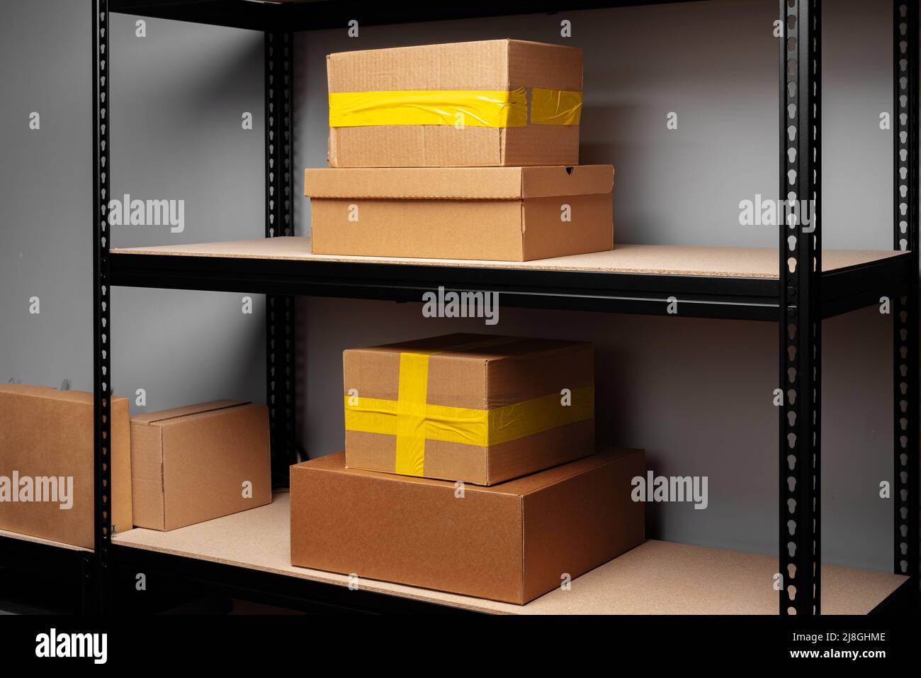 Rack shelves with paper boxes in warehouse Stock Photo - Alamy