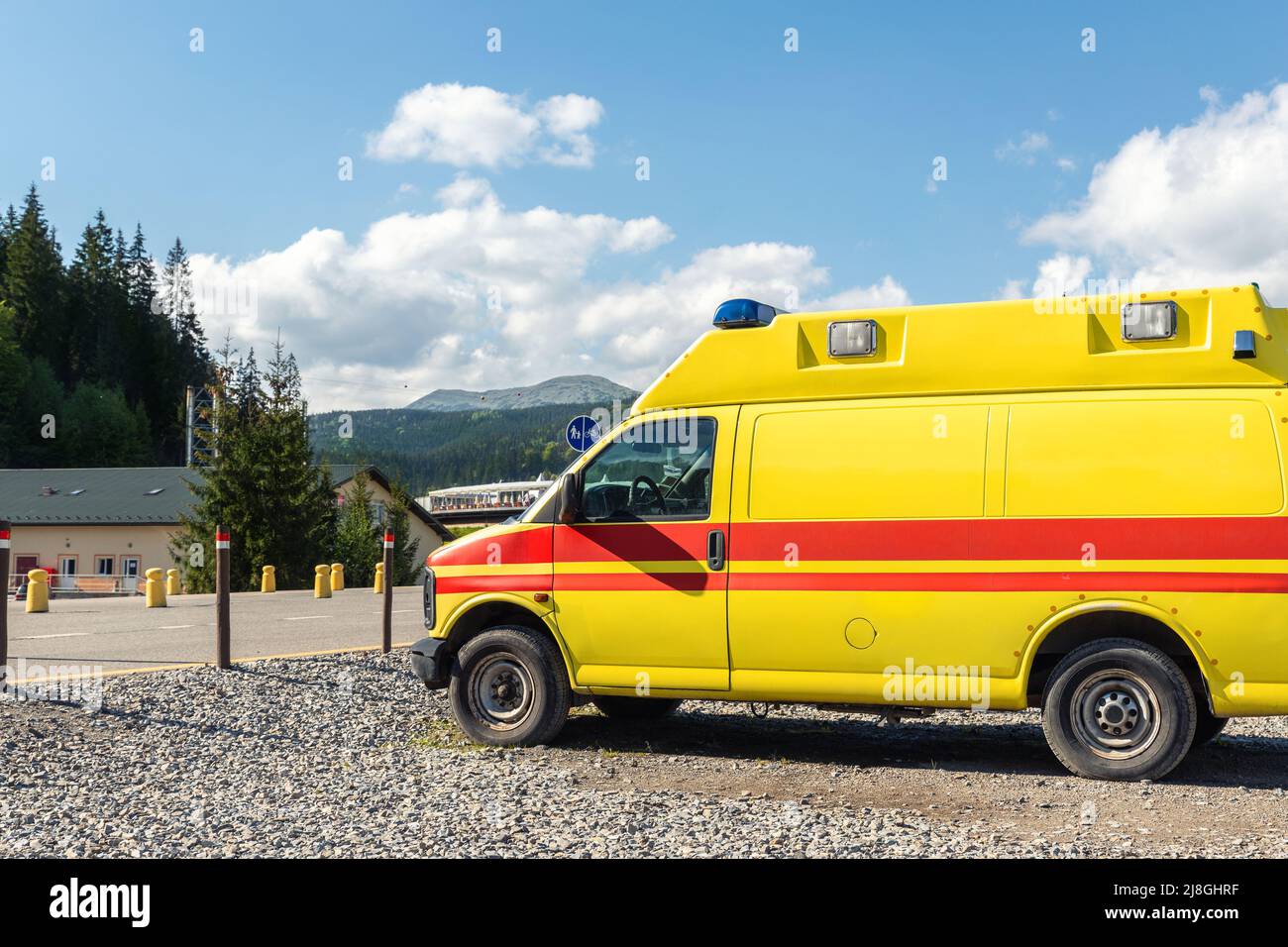 Side view of yellow ambulance rescue ems van car parked near ...